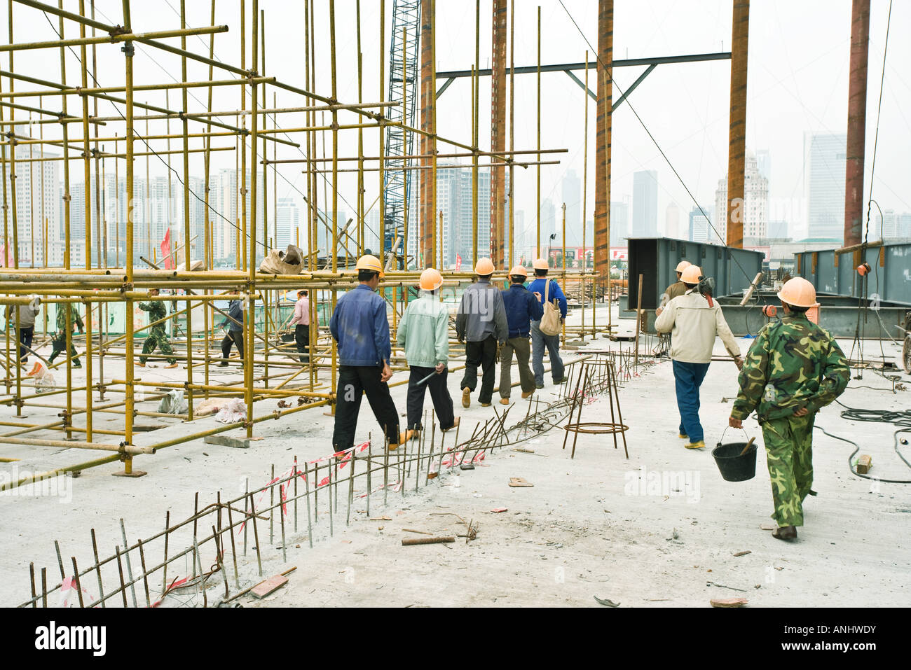 Construction workers leaving construction site Stock Photo - Alamy