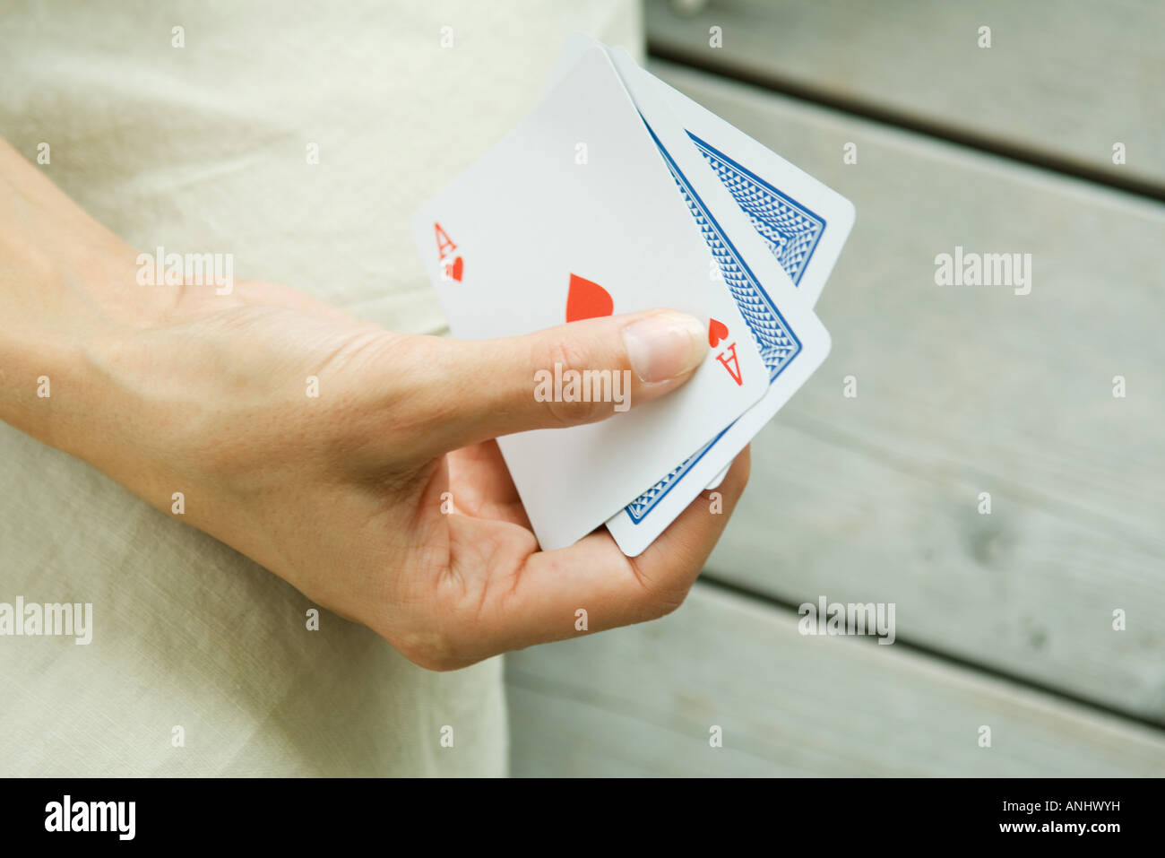 Woman playing card game, cropped view of hand holding cards Stock Photo ...