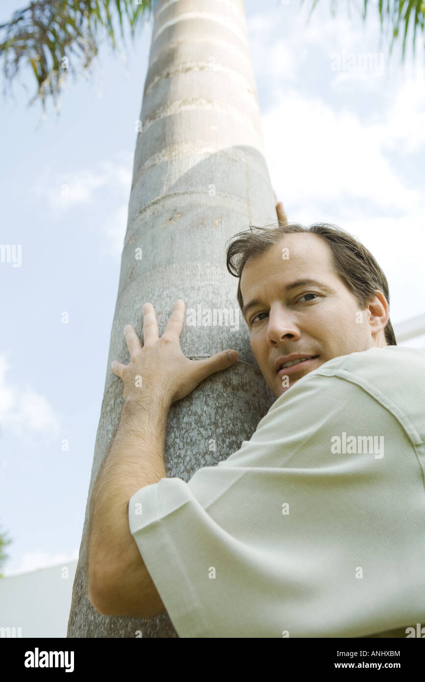 Man leaning against palm tree hi-res stock photography and images - Alamy