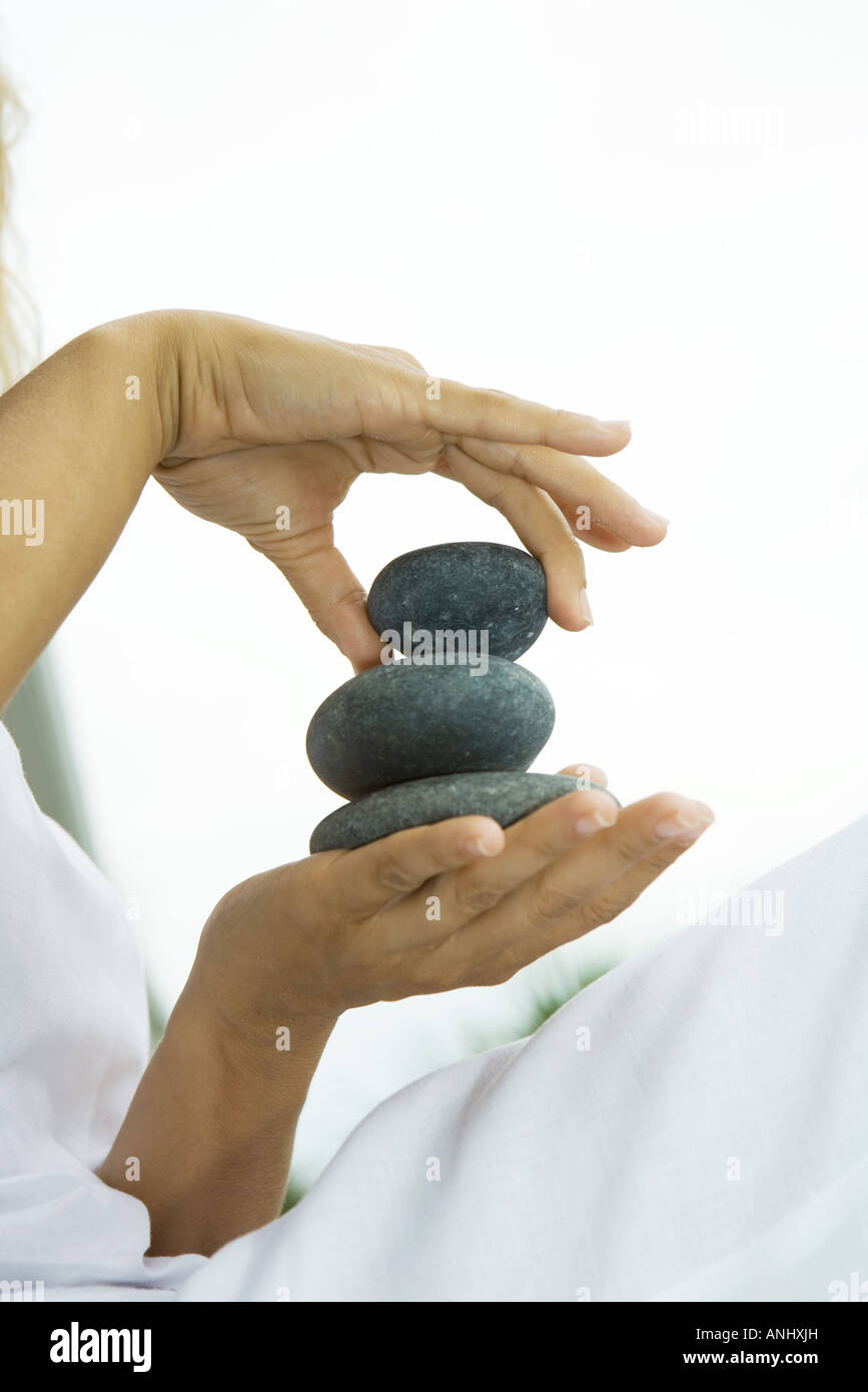 Person stacking pebbles in hand, cropped view Stock Photo - Alamy