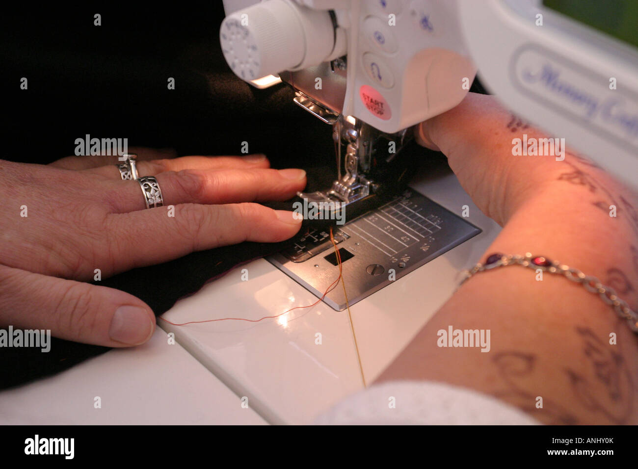 woman using sewing machine Stock Photo - Alamy