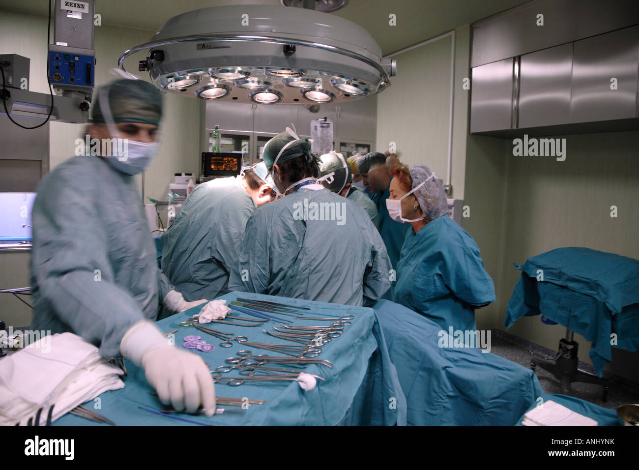 surgical team in operating theatre and instruments laid out ready ...