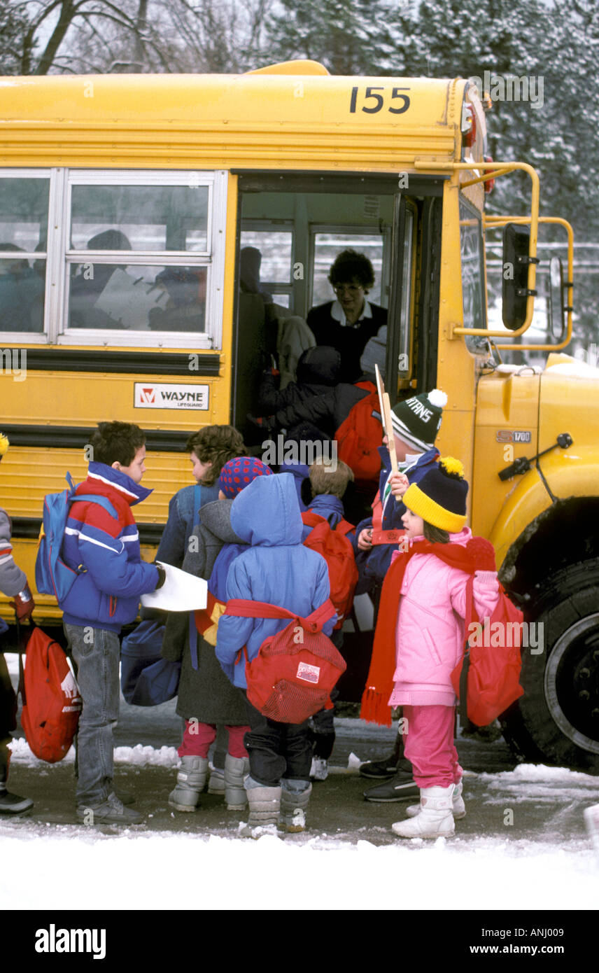 Elementary patrol boy supervises the boarding of a school bus by ...