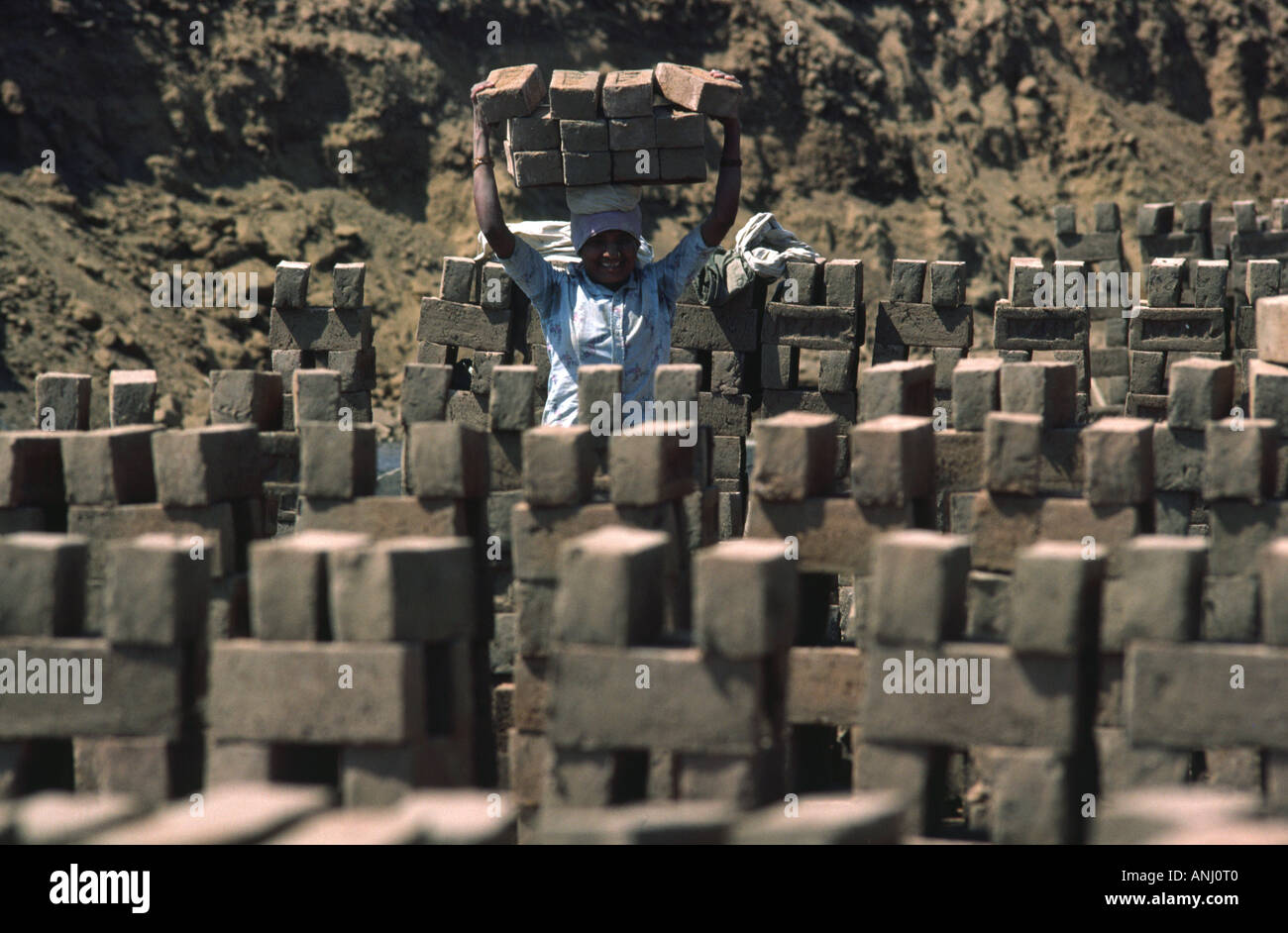 A male laborer working in a brickworks, involving the hard physical ...