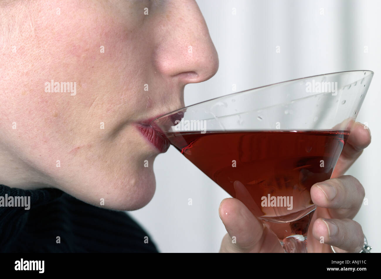 Woman sips drink in glass Model released and Property released Image ...
