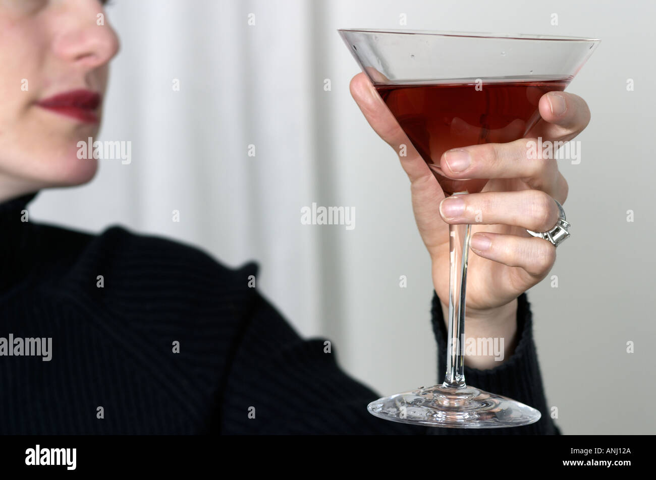 Woman sips drink in glass Model released and Property released Image ...