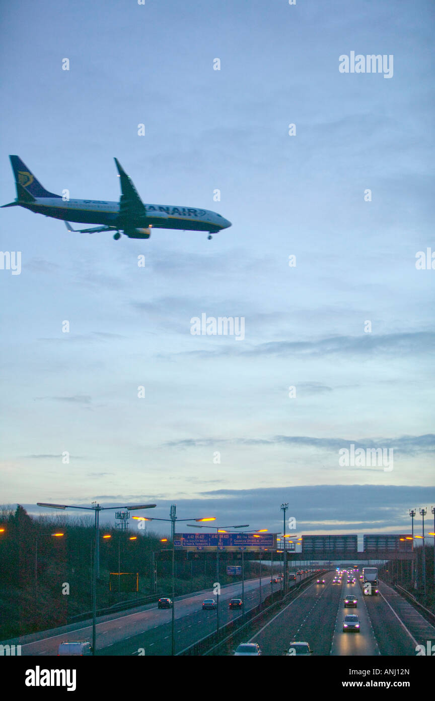 A plane flying over the M1 motorway in Leicestershire UK to land at ...