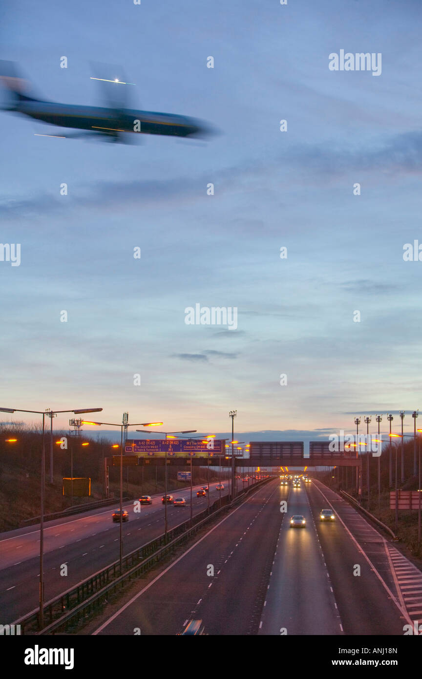 A plane flying over the M1 motorway in Leicestershire UK to land at ...