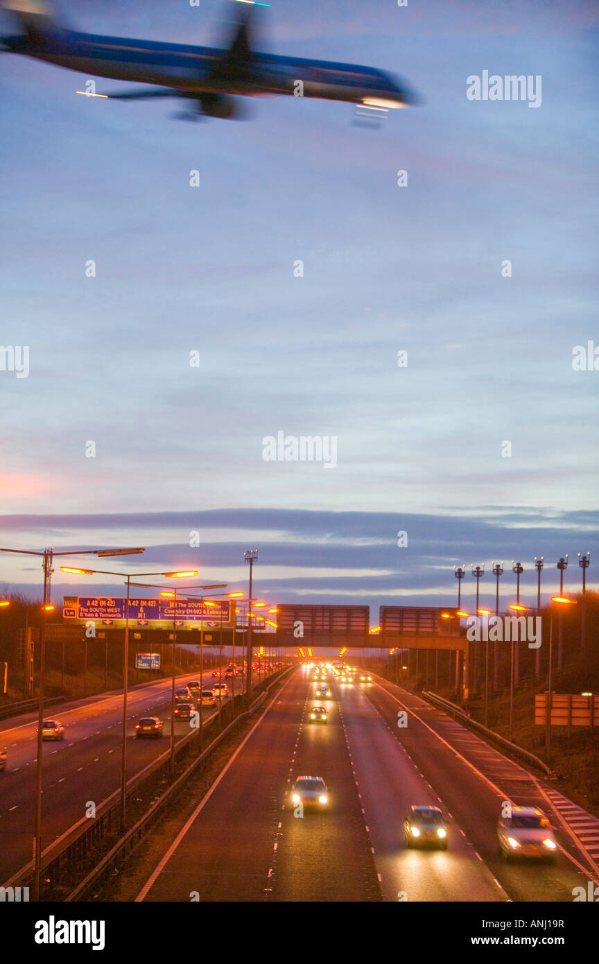 A plane flying over the M1 motorway in Leicestershire UK to land at ...