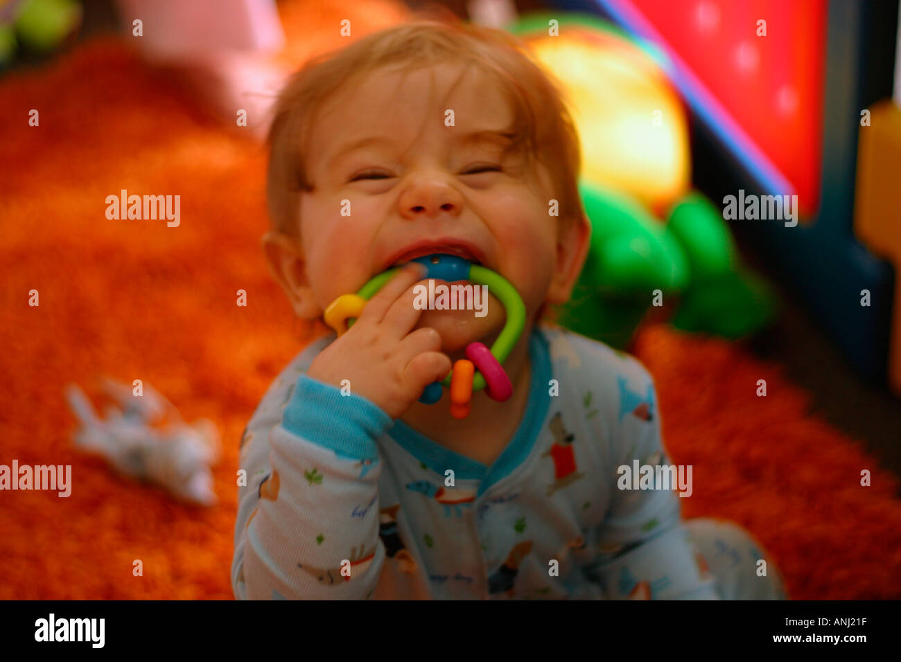 Happy toddler smiles with toy in mouth Model released and Property ...