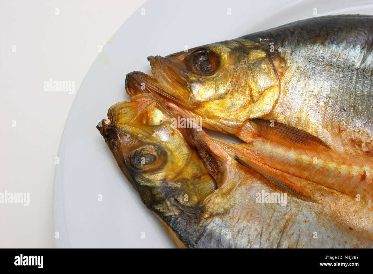 Traditional whole smoked Kipper close up of the head Stock Photo - Alamy