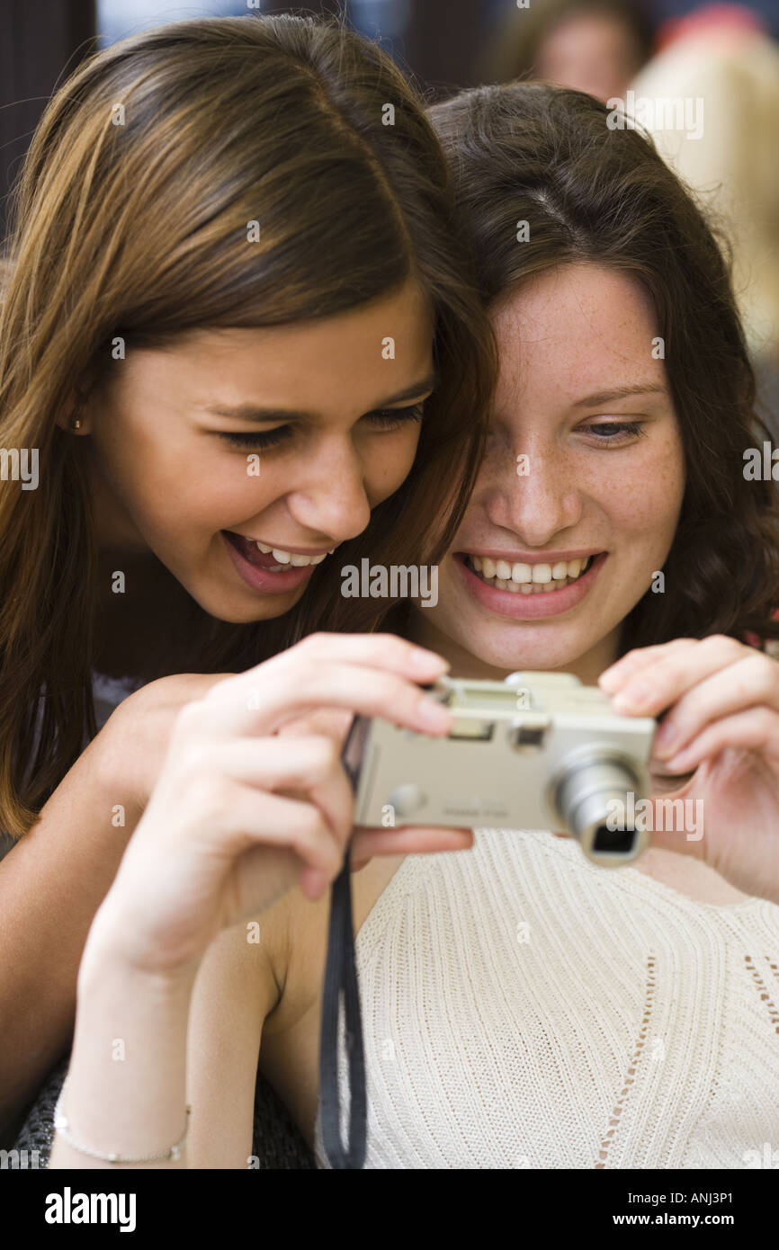 Close up of two teenage girls looking at a camera screen Stock Photo ...