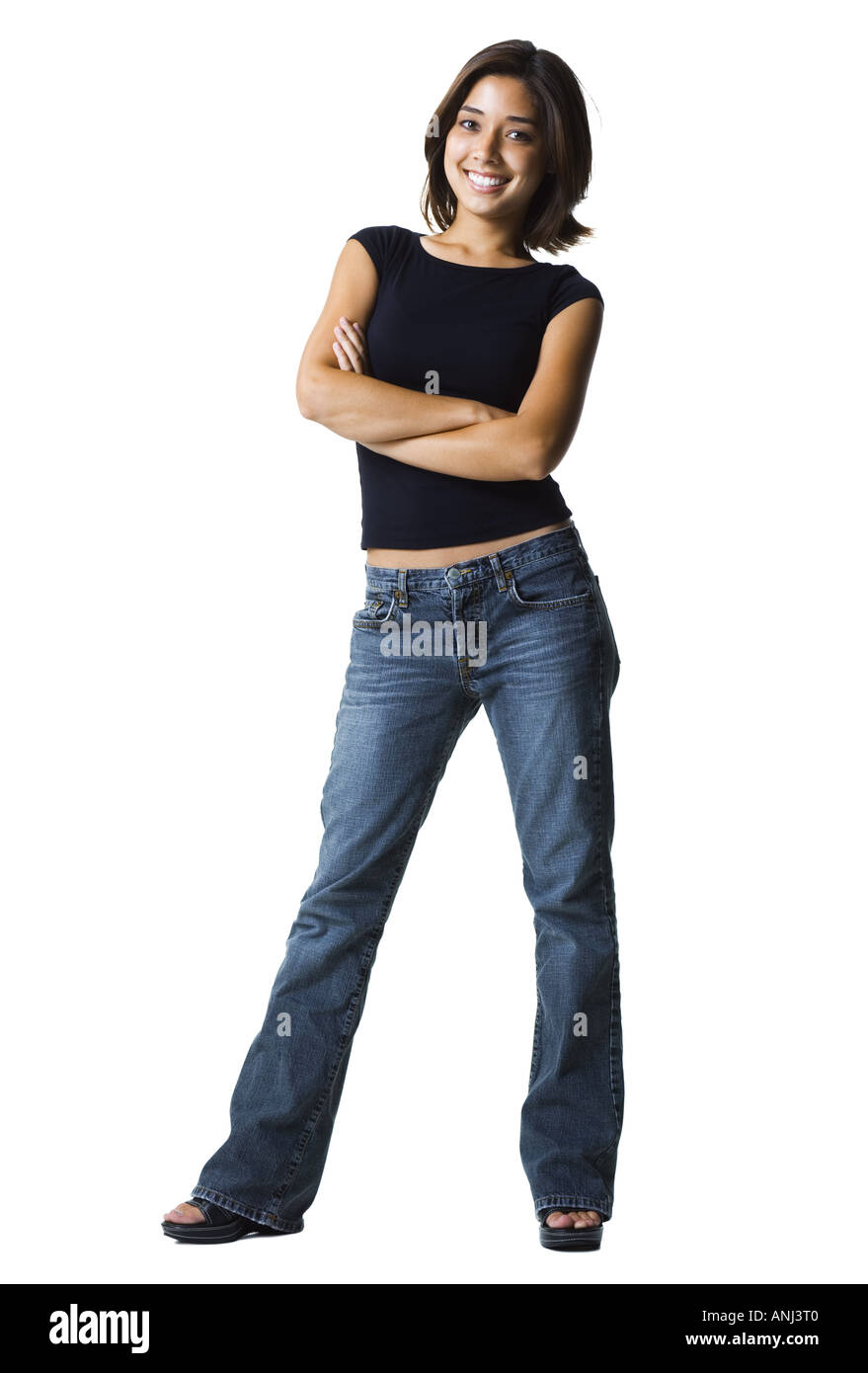 Young woman standing with her arms crossed Stock Photo - Alamy