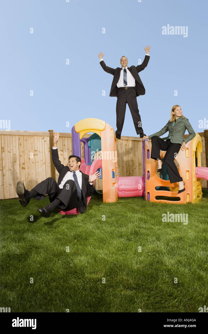Three business executives having fun on a jungle gym Stock Photo - Alamy