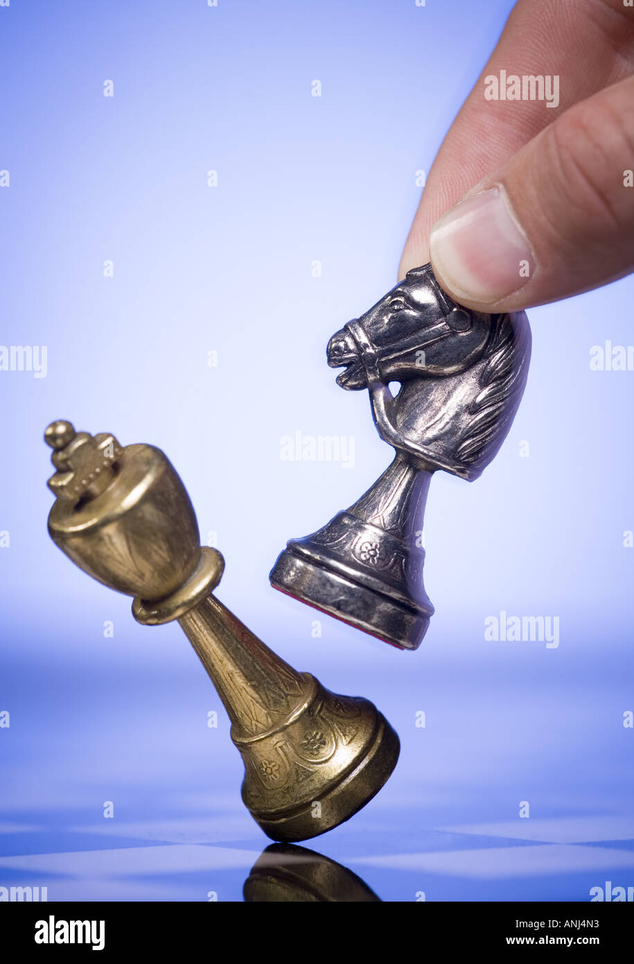 Close up of a person s hand holding a chess piece Stock Photo - Alamy