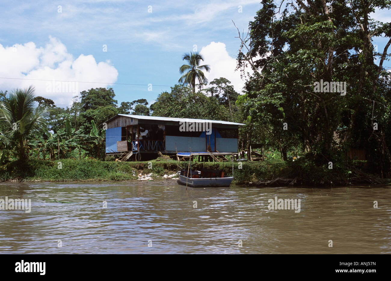 Typical village house on riverbank of Parismina River from water Boat ...