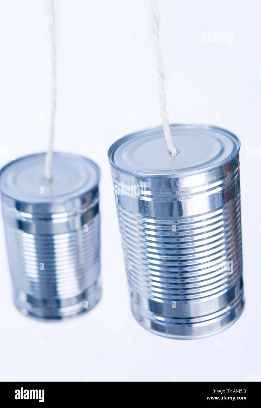 Silver tin cans connected by string Stock Photo - Alamy