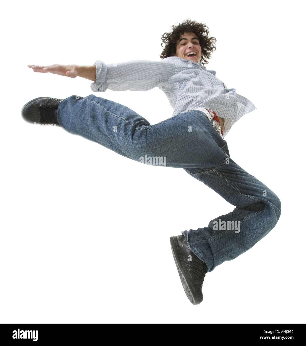 Low angle view of a teenage boy jumping in mid air and smiling Stock ...