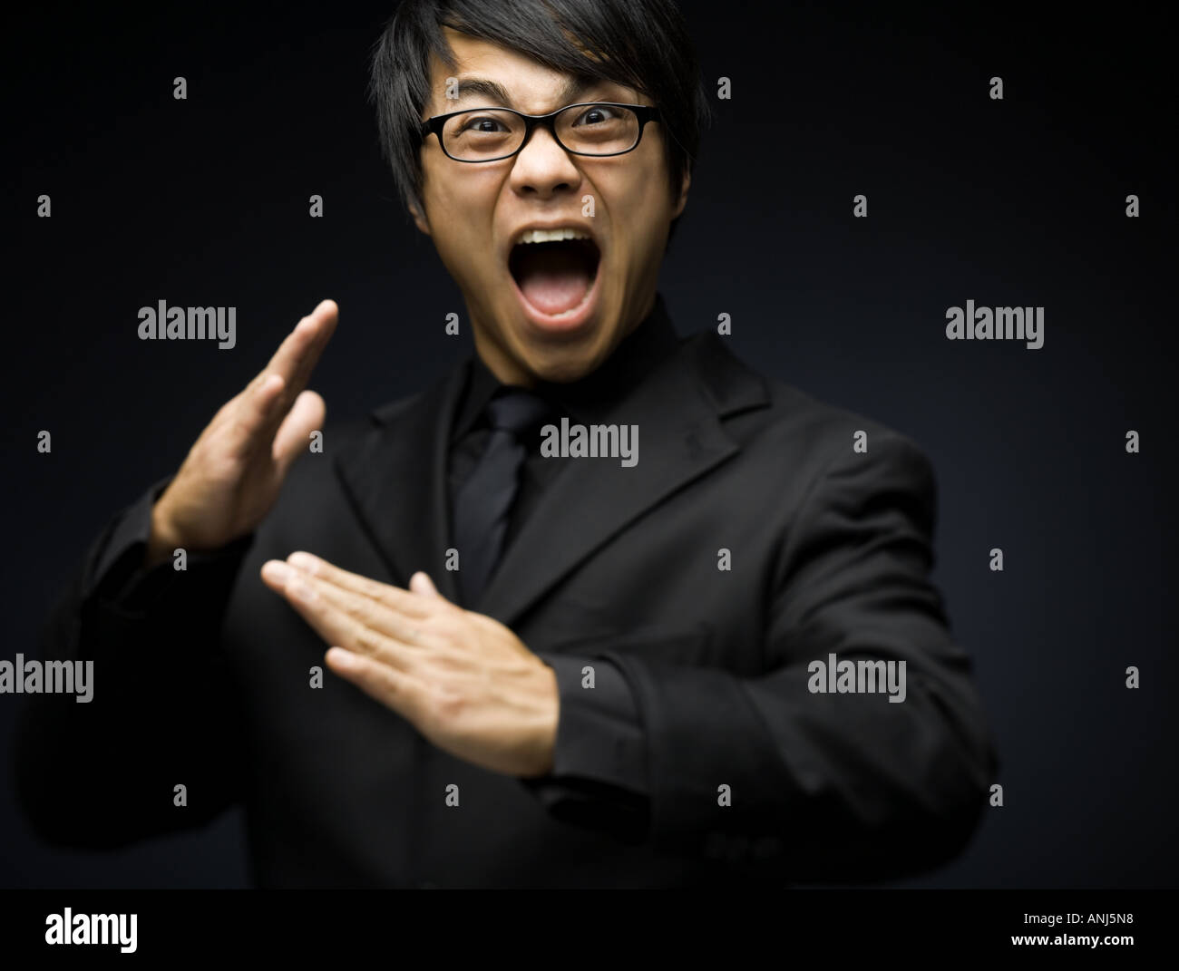 Portrait of a young man shouting in martail arts pose Stock Photo - Alamy
