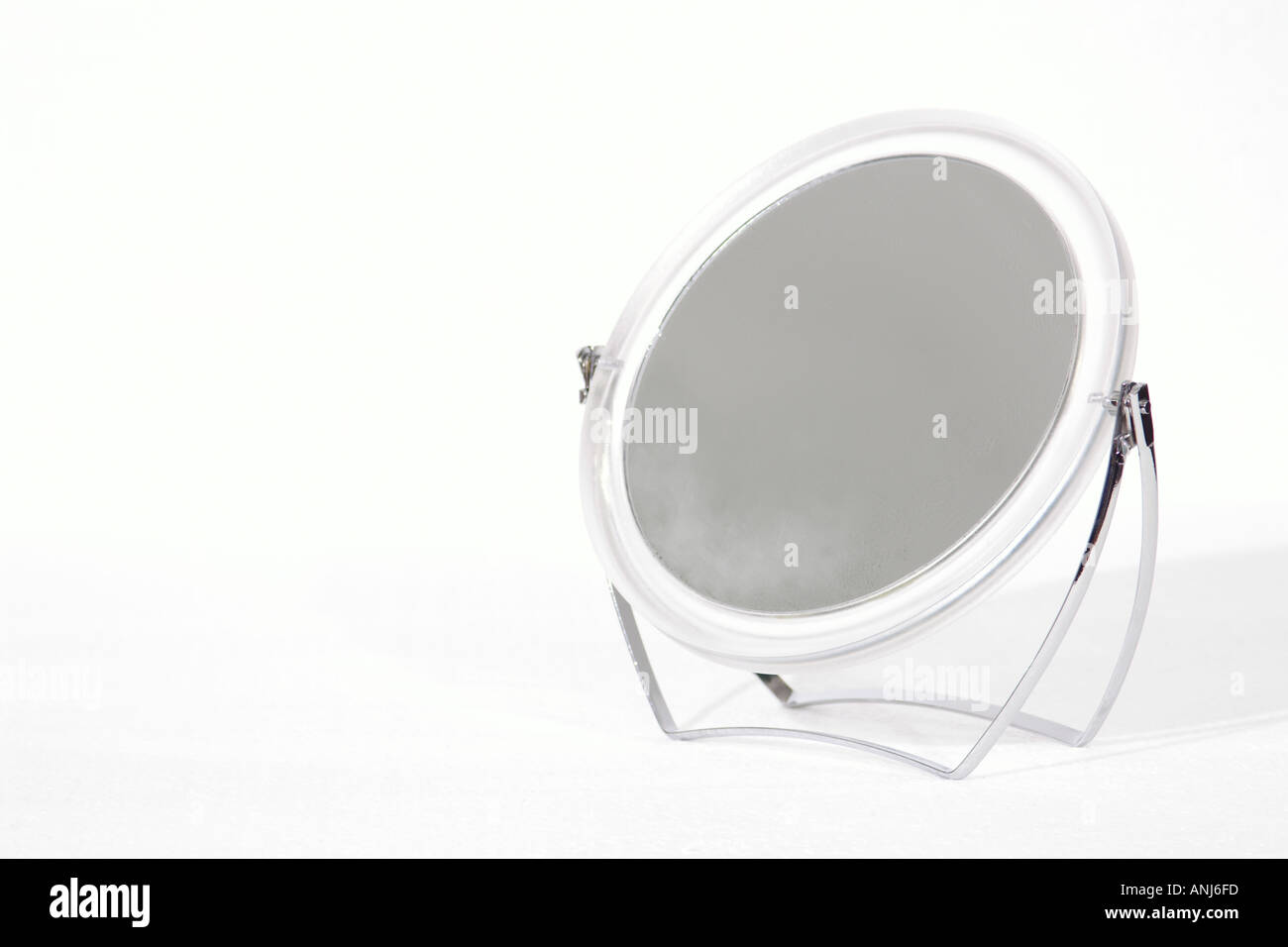 round mirror partially steamed Stock Photo - Alamy