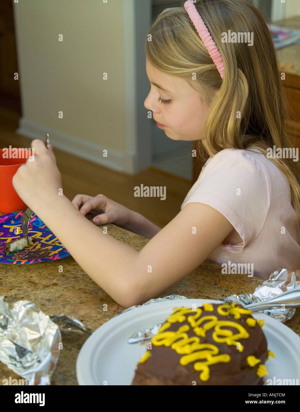 Child eating a piece of birthday cake Stock Photo - Alamy