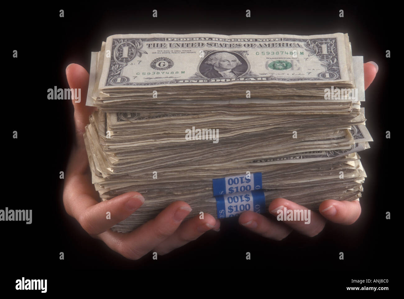 two hands holding stacks of one dollar bills US Stock Photo - Alamy