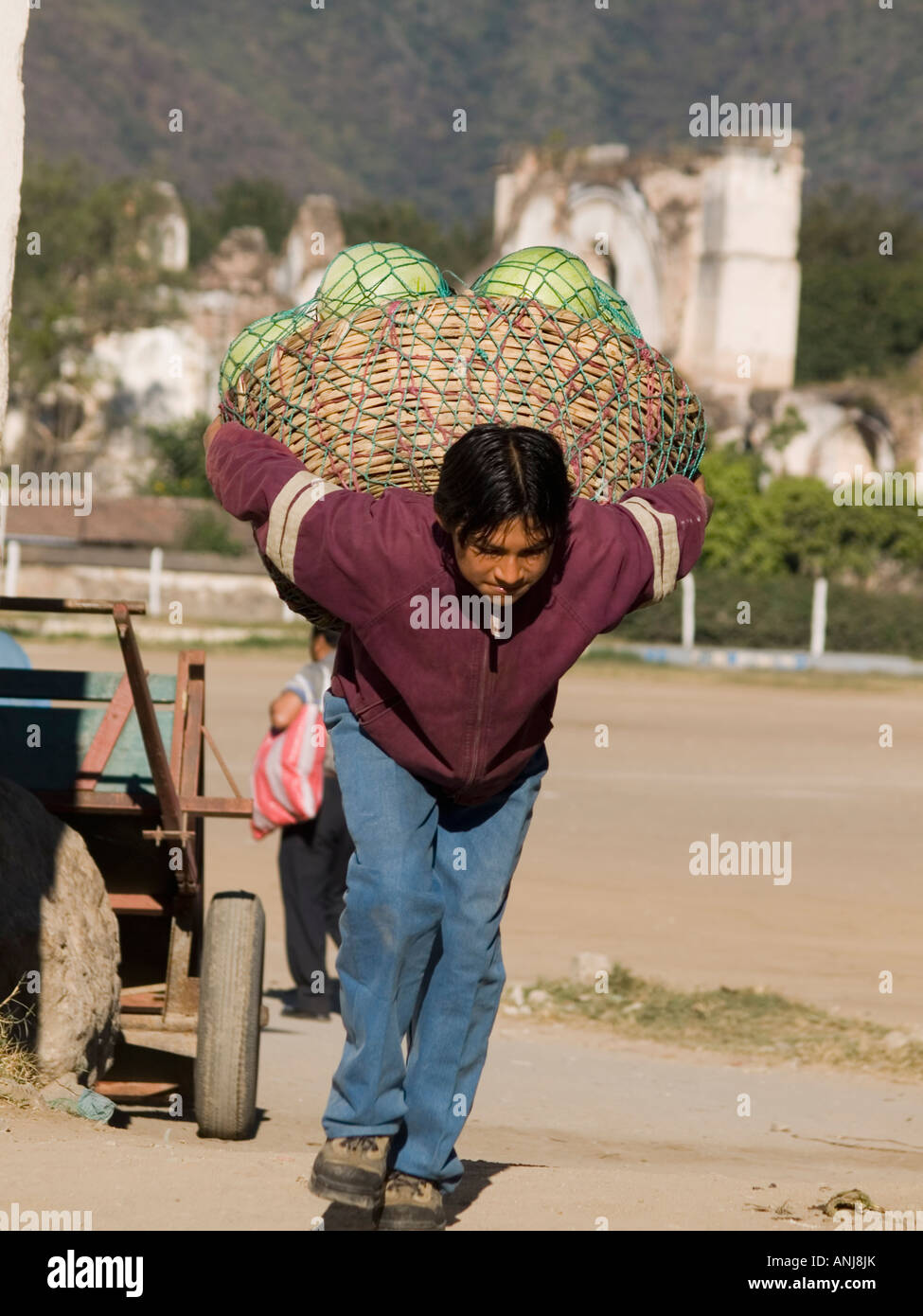 Young man carries goods to market Stock Photo - Alamy