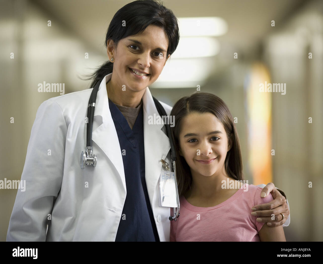Portrait of a female doctor standing with a female patient Stock Photo ...