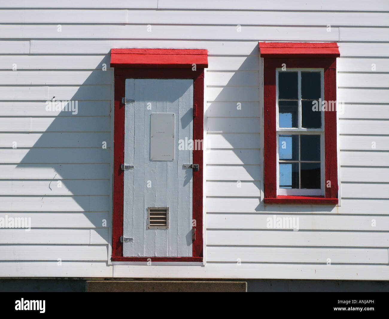 An old lighthouse presents some interesting geometry with a red trimmed ...