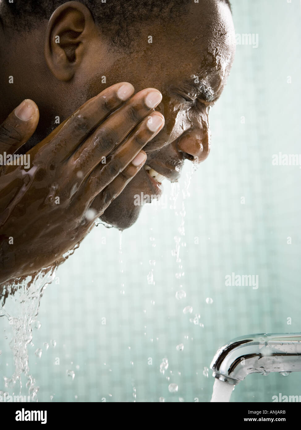Close up of a mid adult man washing his face Stock Photo - Alamy