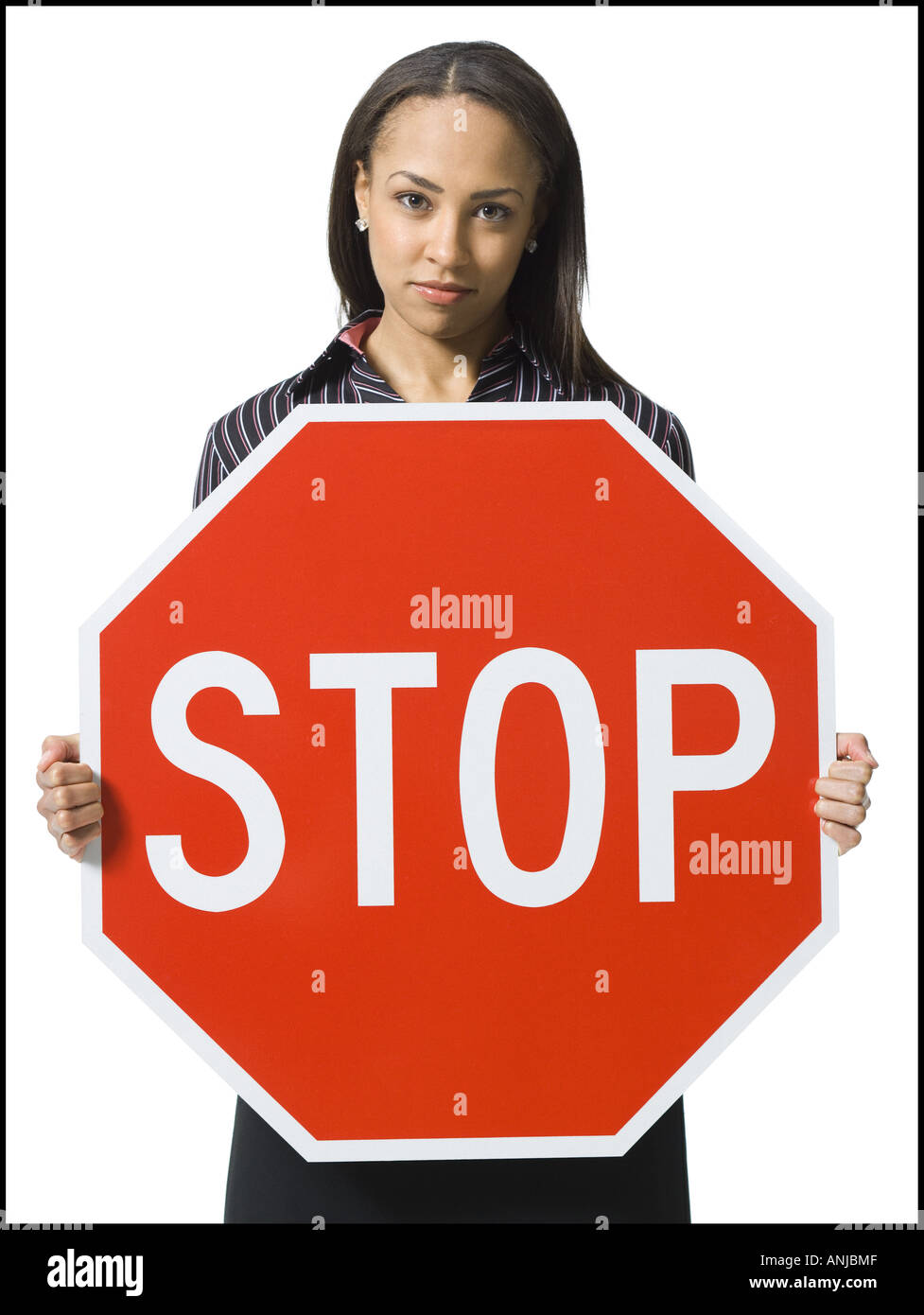 Portrait of a young woman holding a stop sign Stock Photo - Alamy