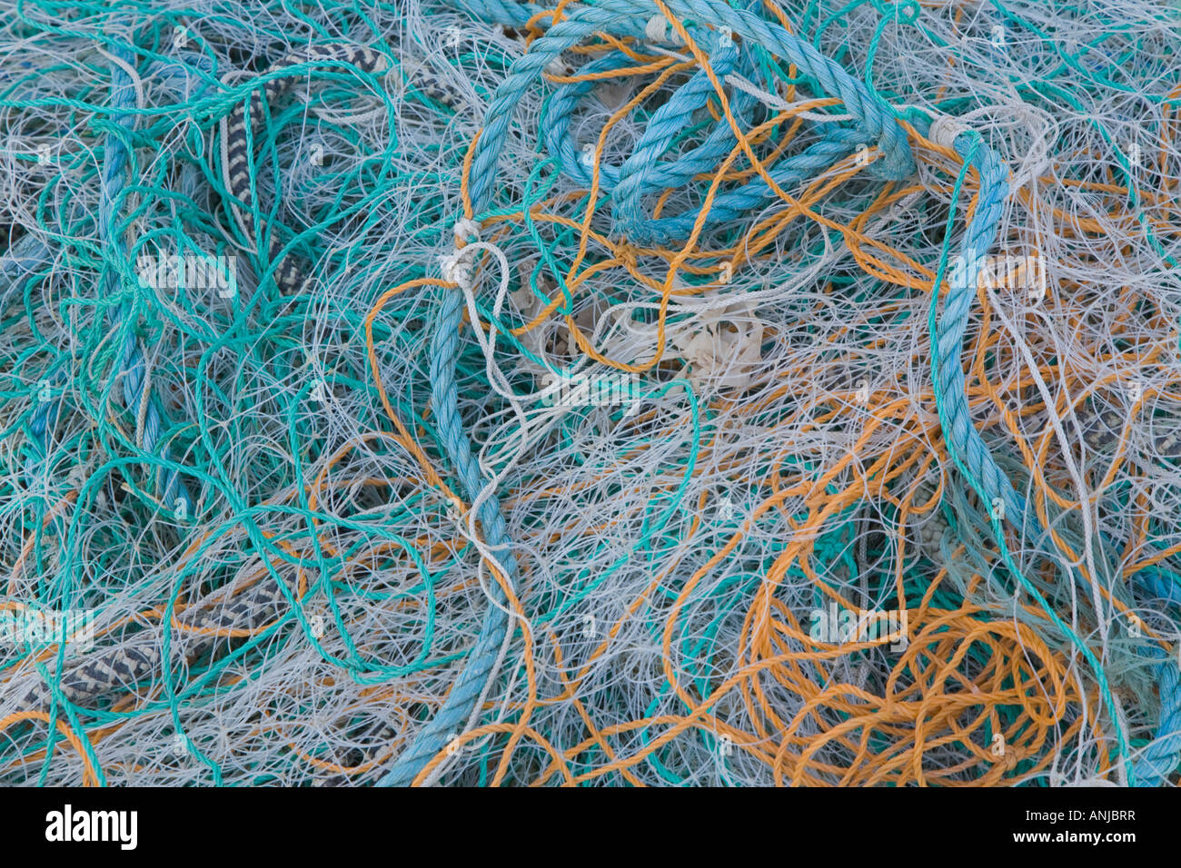 A colourful tangle of fishing nets and ropes on the ground Stock Photo ...