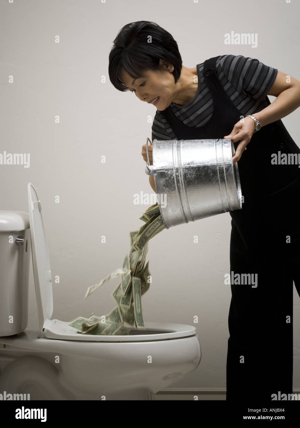 Woman emptying bucket hi-res stock photography and images - Alamy
