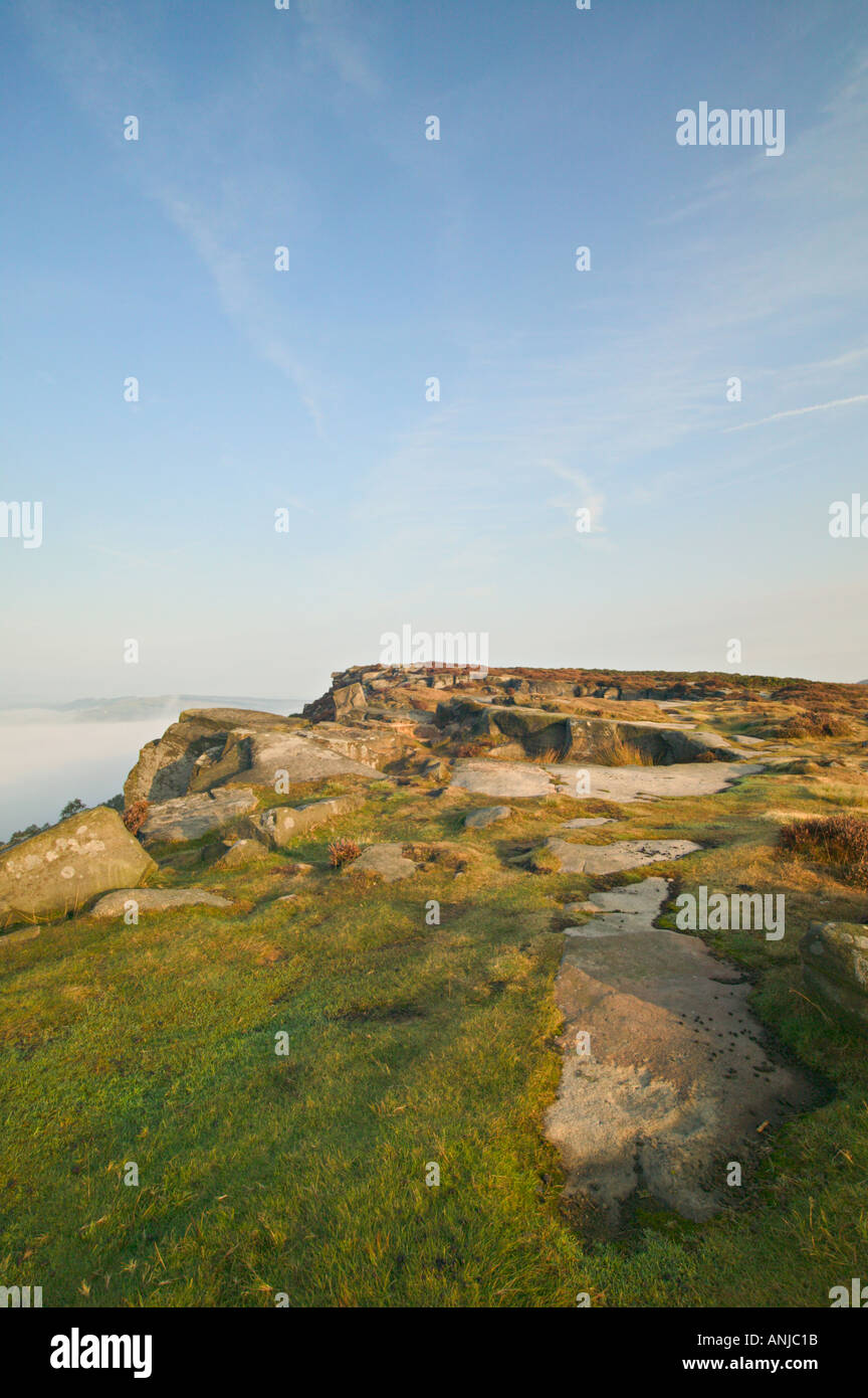 View along Curbar Edge above Curbar Village, under a blue sky with ...