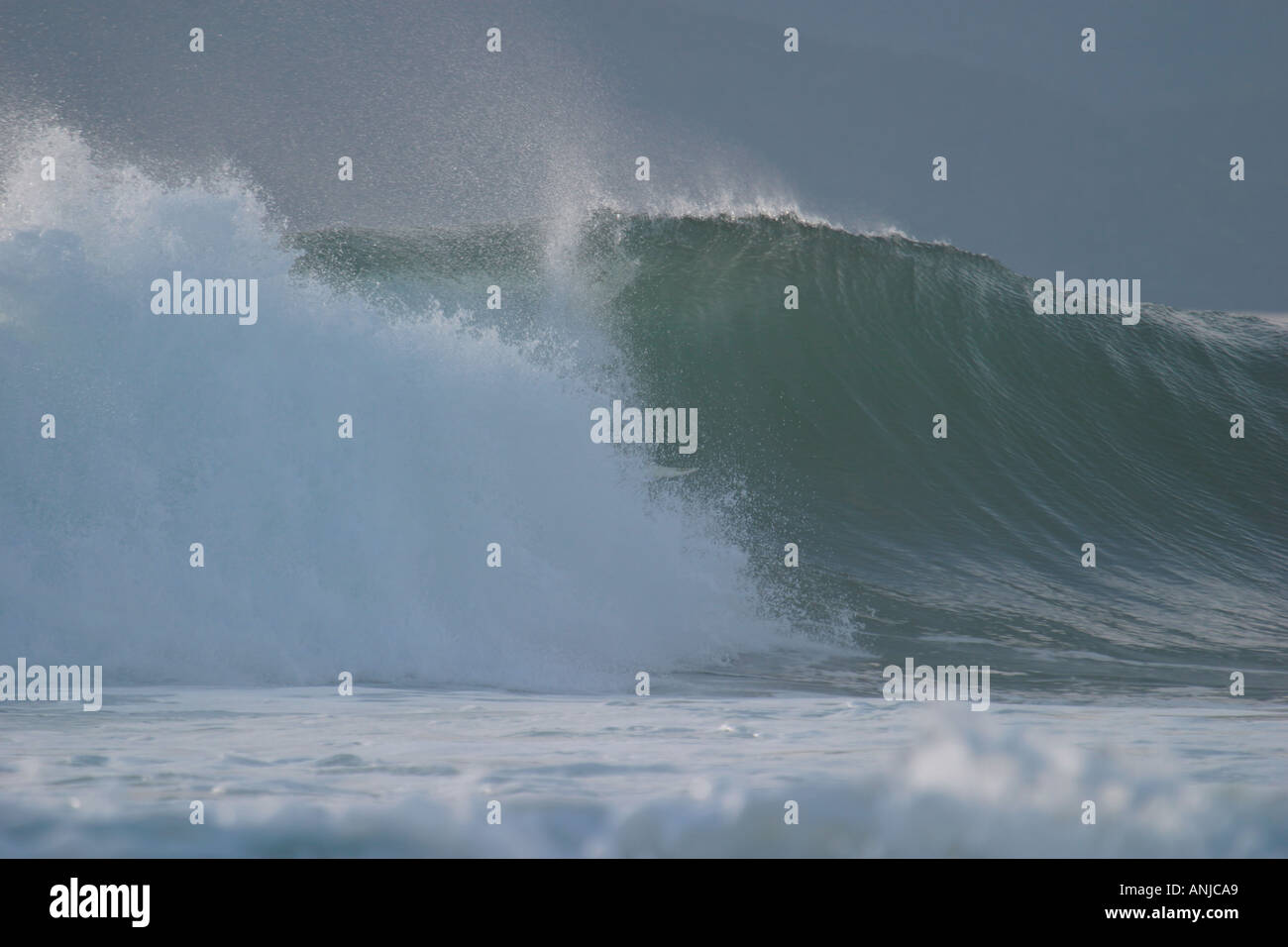 man inside wave going left indonesia Stock Photo - Alamy