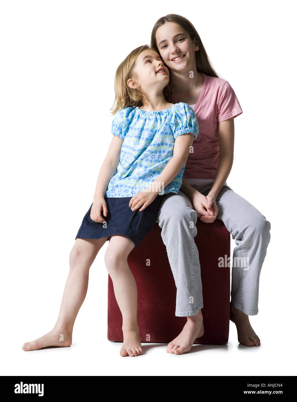 Smiling girls sitting on Cut Out Stock Images & Pictures - Alamy