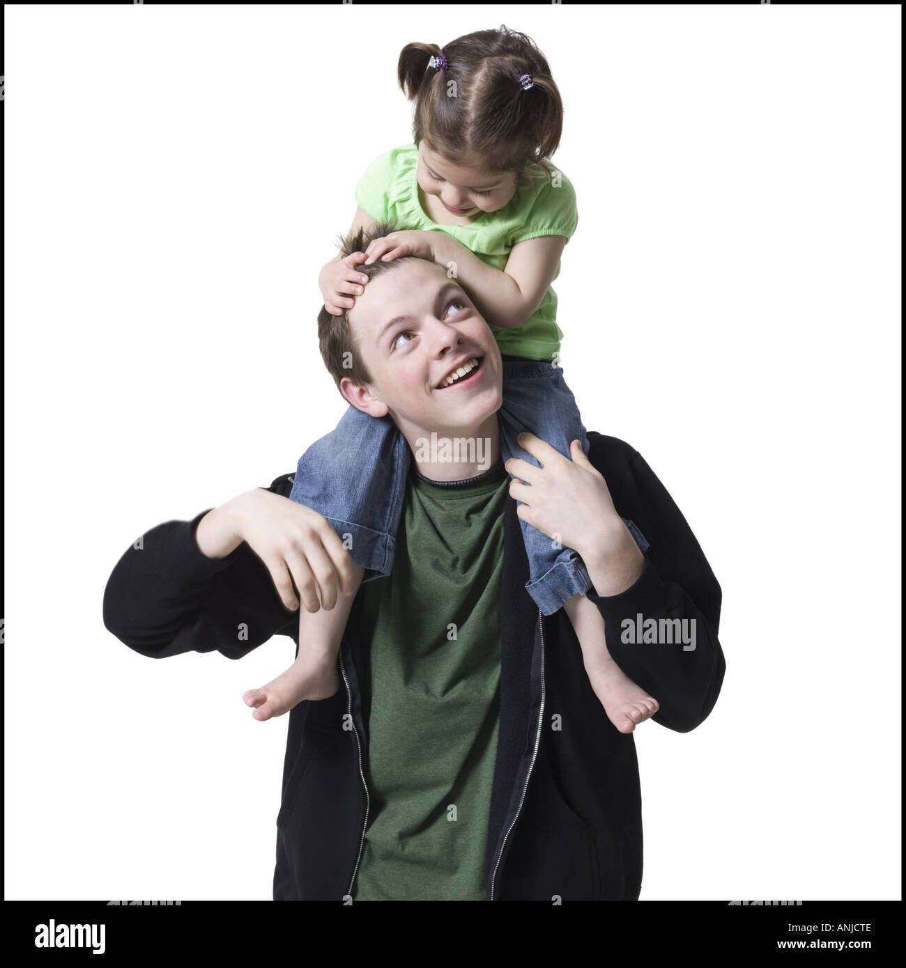 Close up of a brother carrying his sister on his shoulders Stock Photo ...