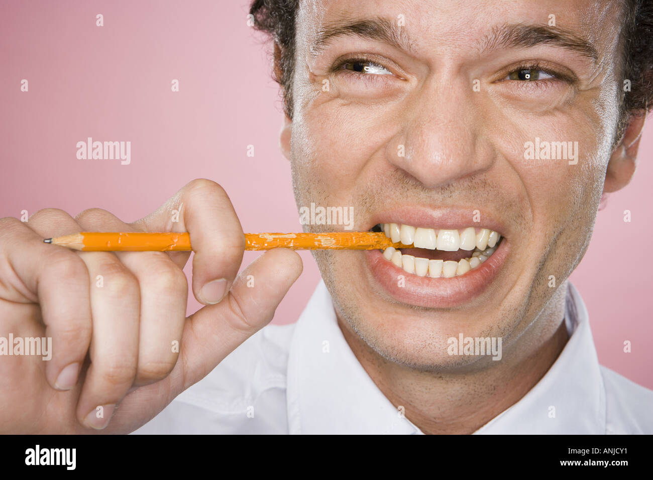 Biting pencil man hi-res stock photography and images - Alamy
