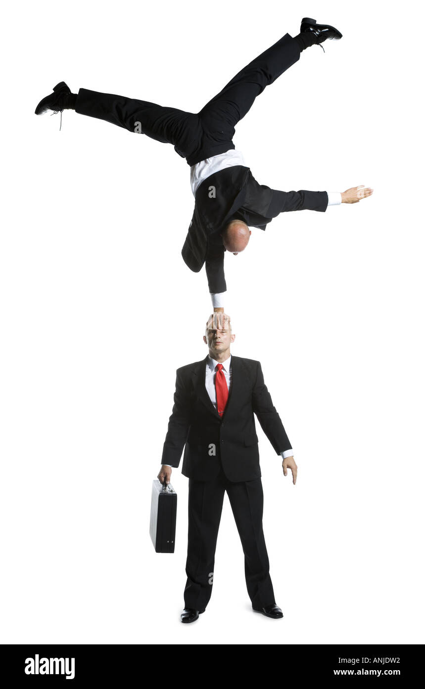 High angle view of two male acrobats in business suits performing Stock ...