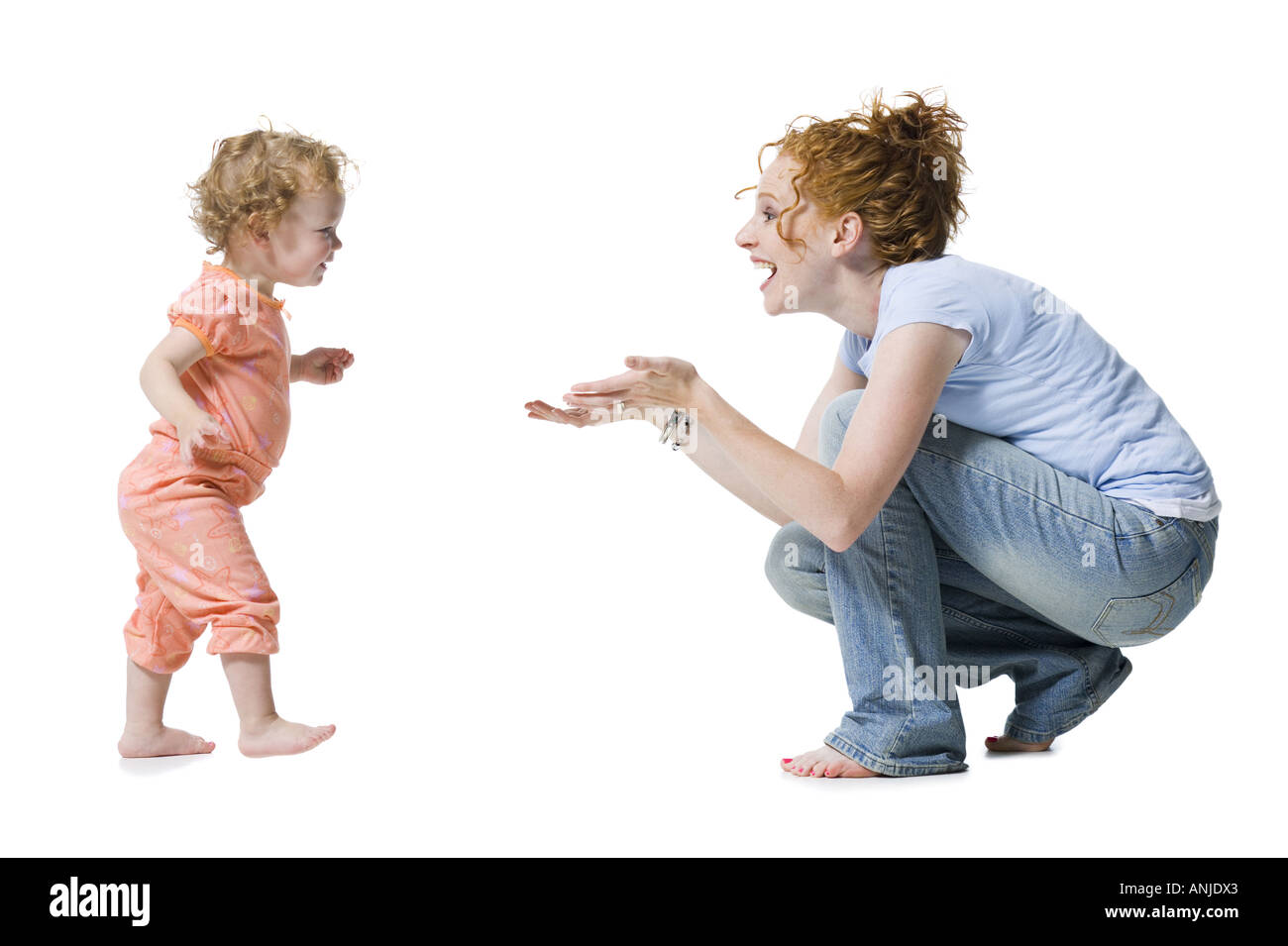 Profile of a baby girl reaching for her mother Stock Photo - Alamy