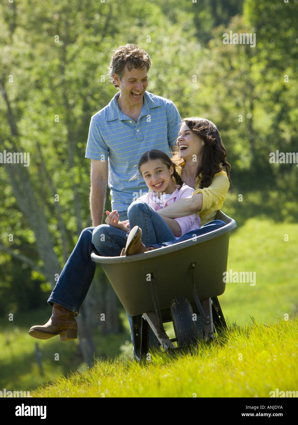 Man pushing his daughter and his wife in a wheelbarrow Stock Photo - Alamy Man pushing his daughter and his wife in a wheelbarrow Stock Photo - Alamy