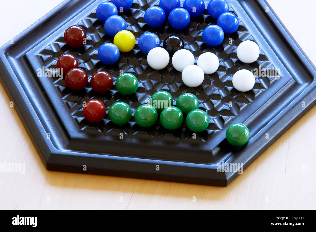 Marble solitaire on wooden surface Stock Photo - Alamy