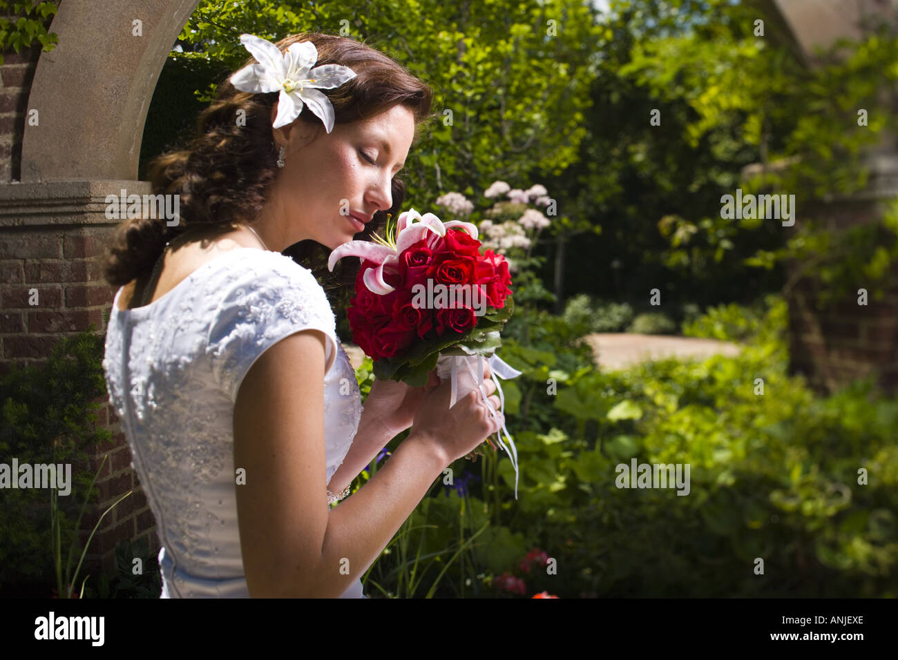 Side profile of a young woman smelling flowers Stock Photo - Alamy
