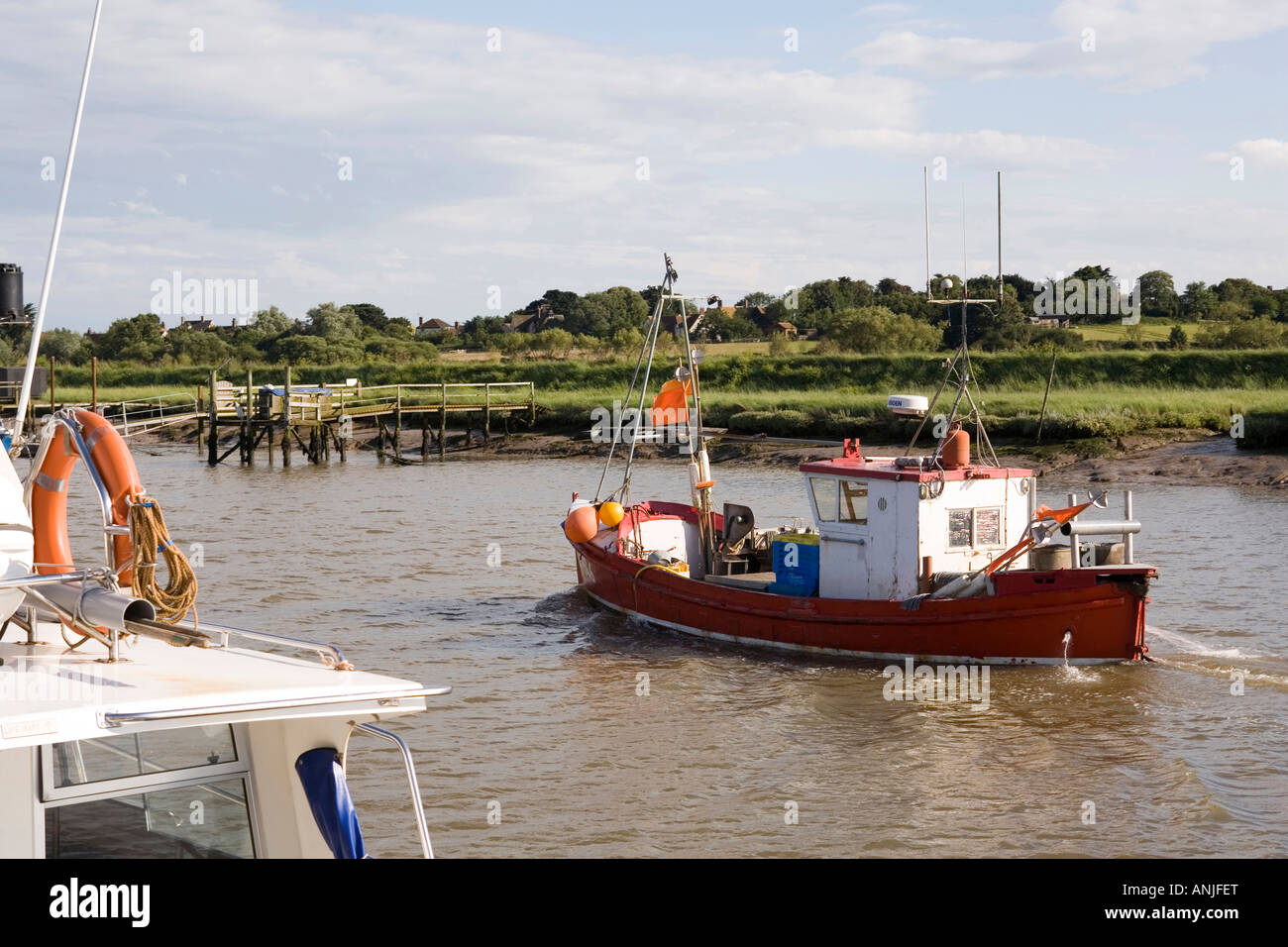 UK Suffolk Southwold Harbour fishing boat leaving River Blyth moorings ...