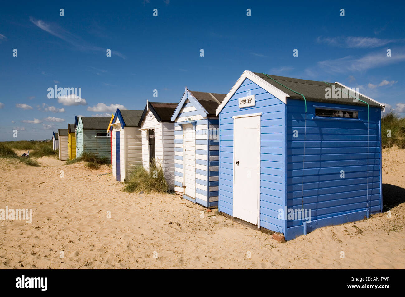 UK Suffolk Southwold beach brightly painted beach huts in the sand ...