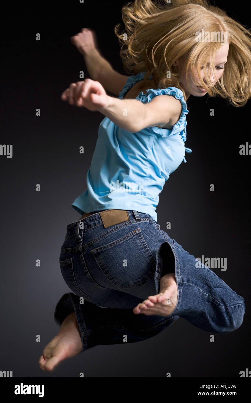 Side profile of a young woman jumping Stock Photo - Alamy