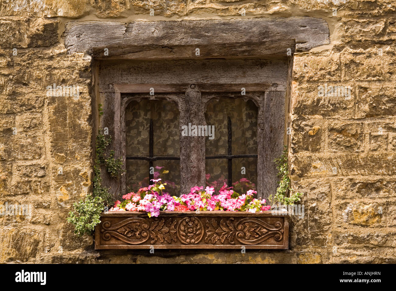 UK Wiltshire Castle Combe village High Street ancient wooden window ...