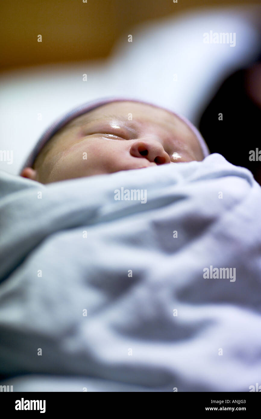 Newborn baby girl wrapped in clothes Stock Photo - Alamy
