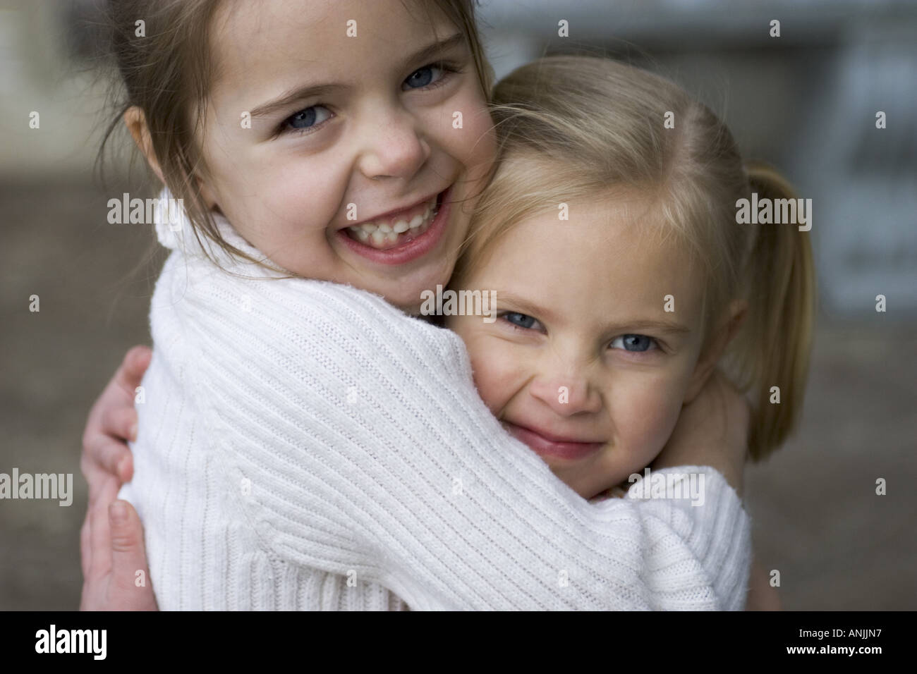 Portrait of two sisters hugging Stock Photo - Alamy