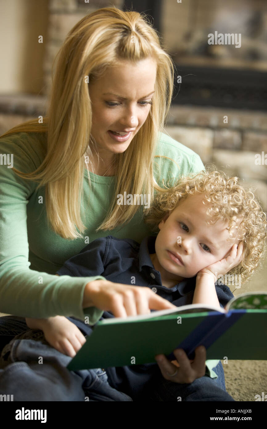 Mother reading a book with her son Stock Photo - Alamy